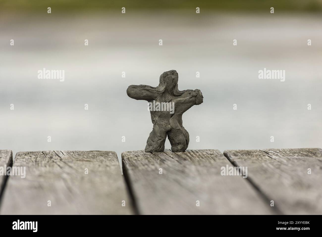 Small clay figure made of sand on a beach Stock Photo - Alamy