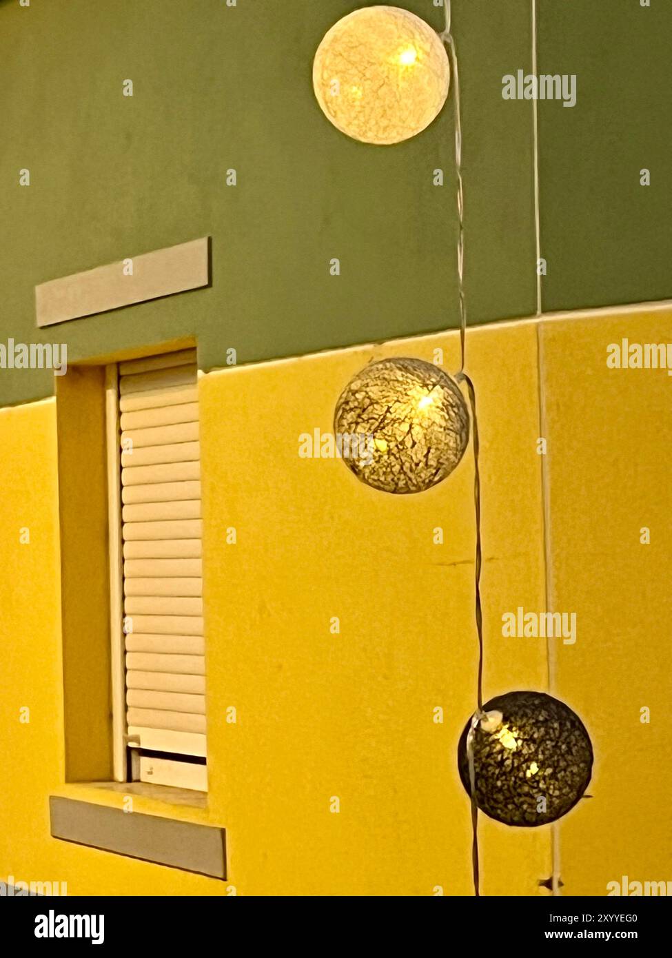Decorative hanging balls in front of bright building and window Stock ...
