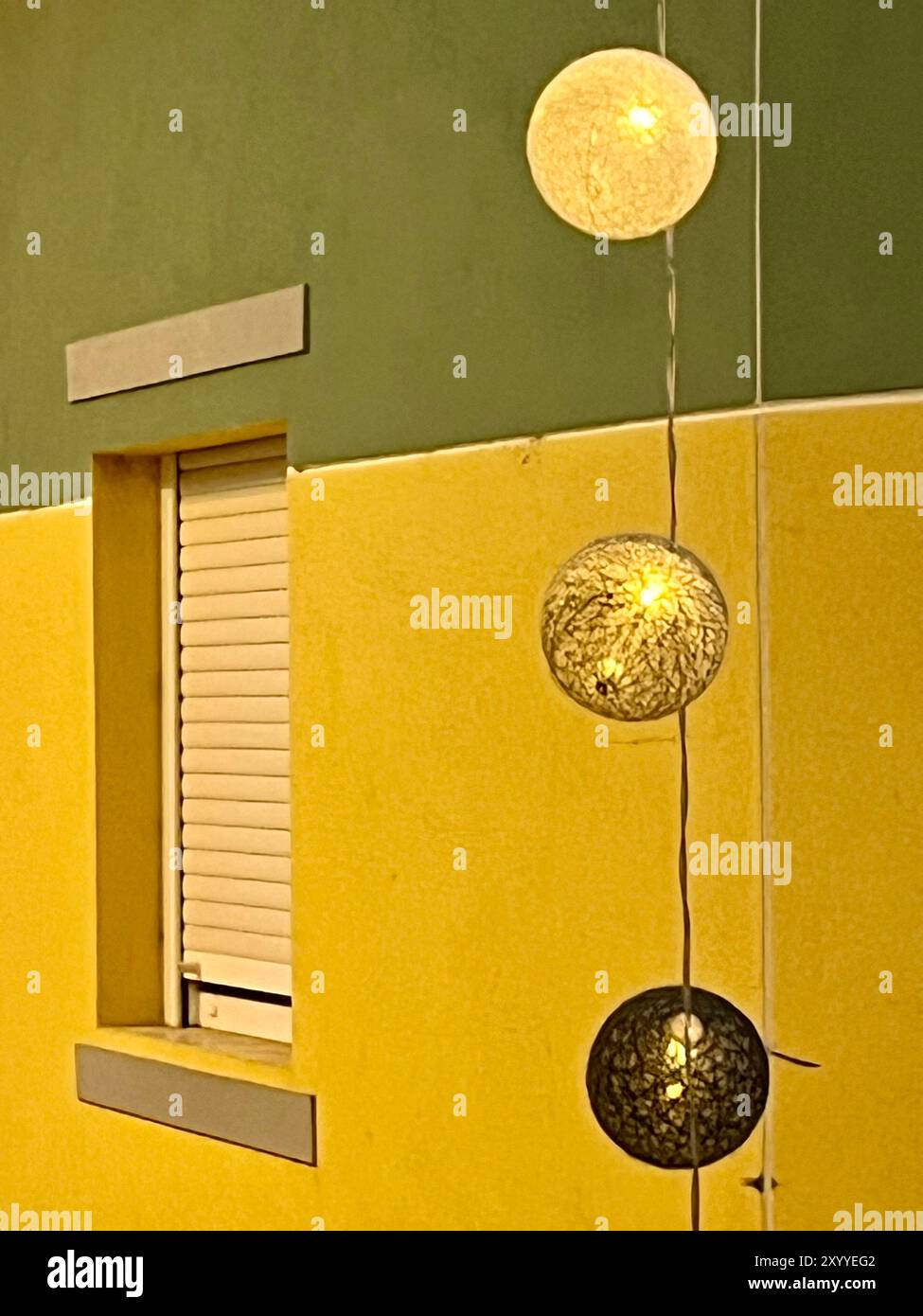 Decorative hanging balls in front of bright building and window Stock ...