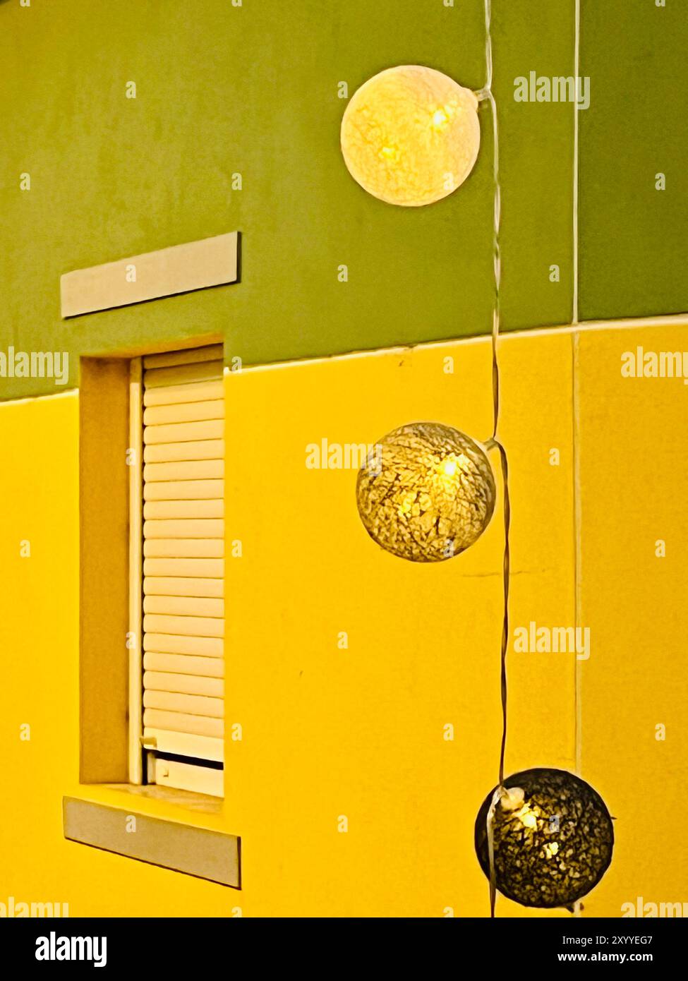 Decorative hanging balls in front of bright building and window Stock ...