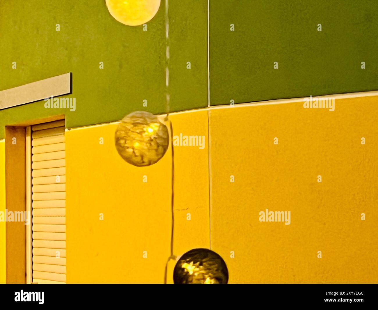 Decorative hanging balls in front of bright building and window Stock ...