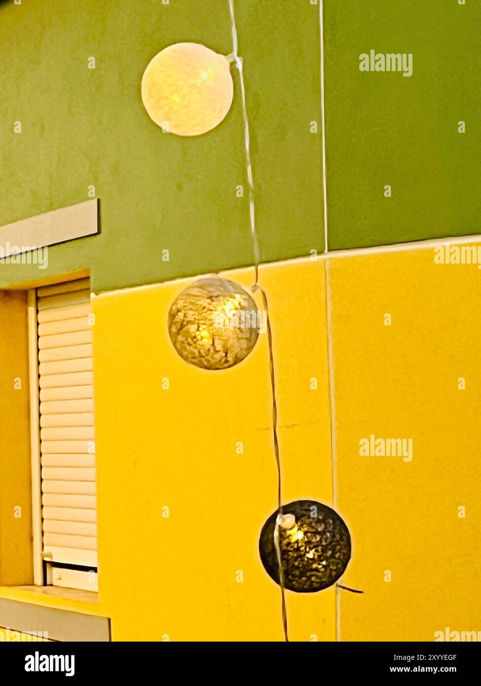 Decorative hanging balls in front of bright building and window Stock ...