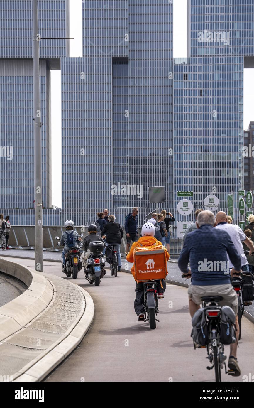 Cyclist on the cycle path of the Erasmus Bridge over the Nieuwe Maas ...