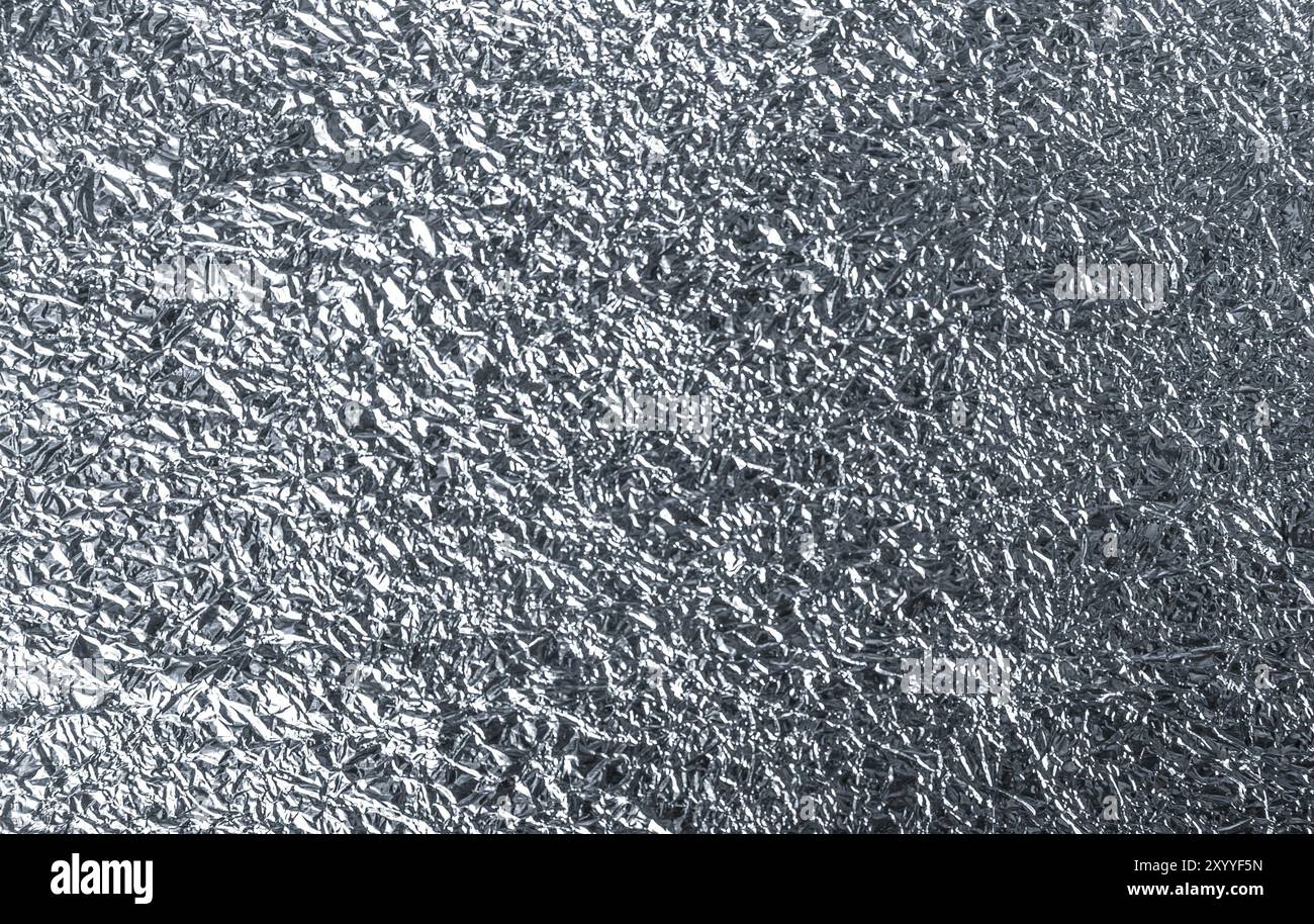 Silver leaf foil background with shiny crumpled uneven surface for texture and background Stock ...