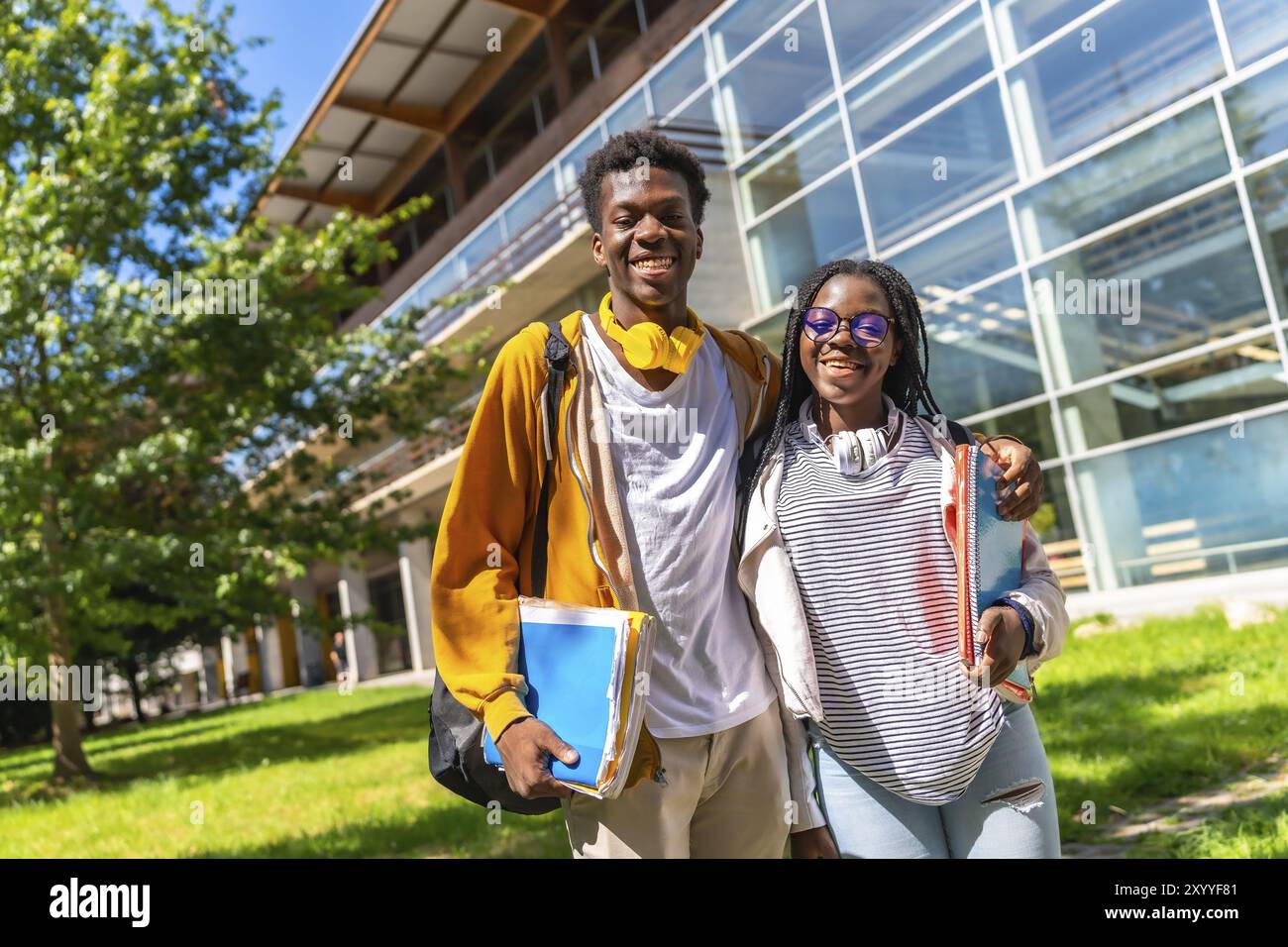 Portrait of two proud and happy african university colleagues standing ...