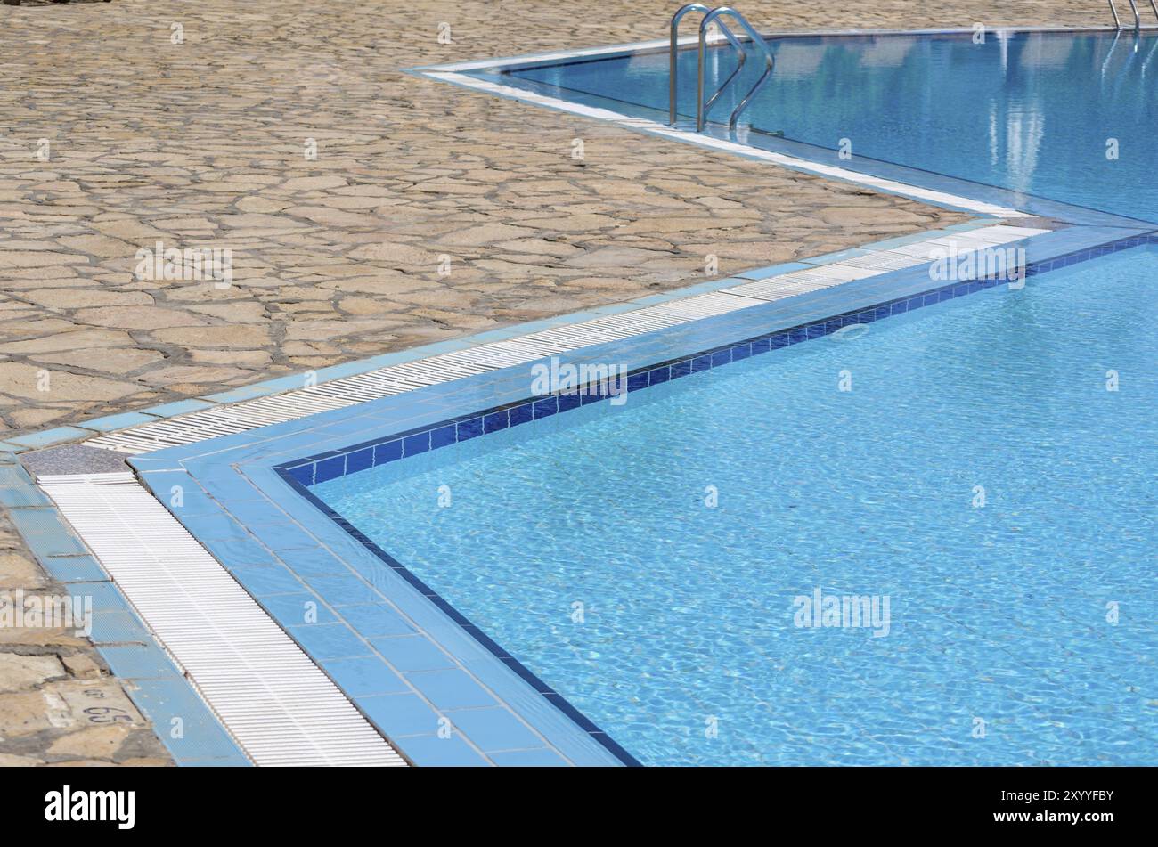 Swimming pool with blue water in the hotel Stock Photo - Alamy