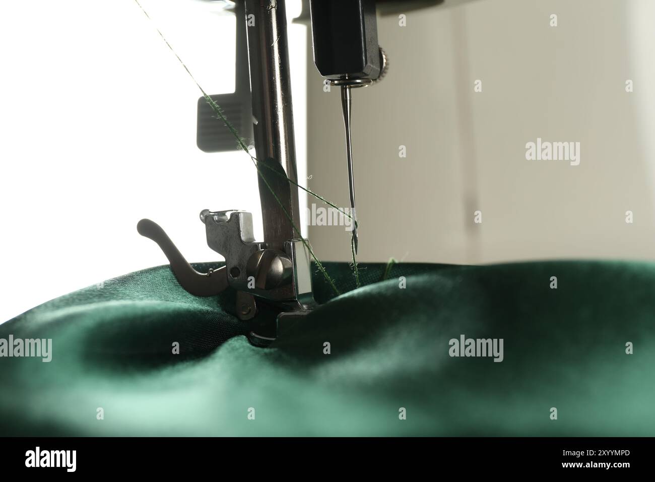 Sewing machine with green fabric on white background, closeup Stock ...