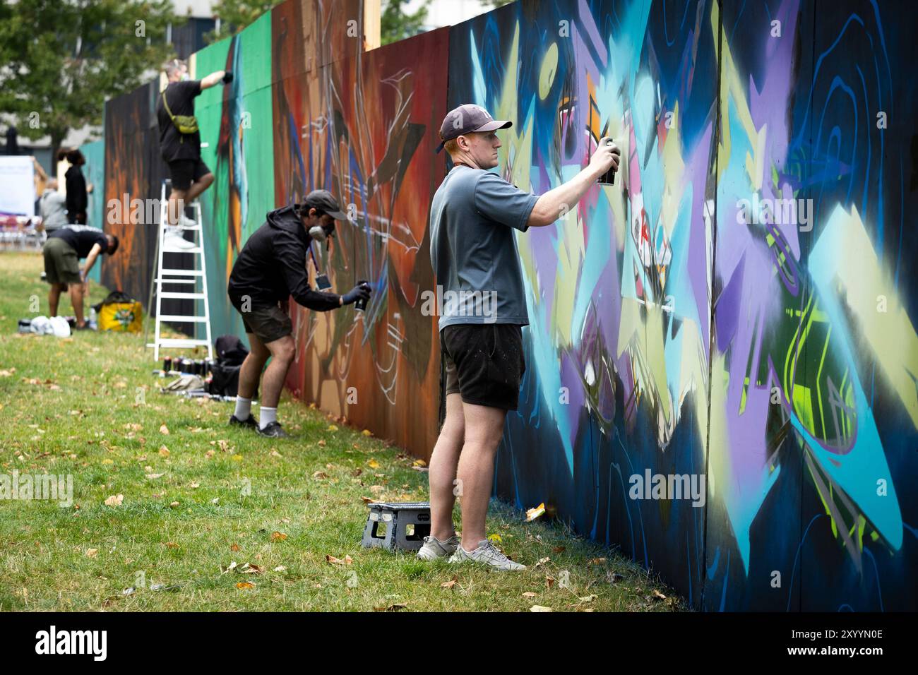 Graffiti artists creating street art pieces at the at the Southend City ...
