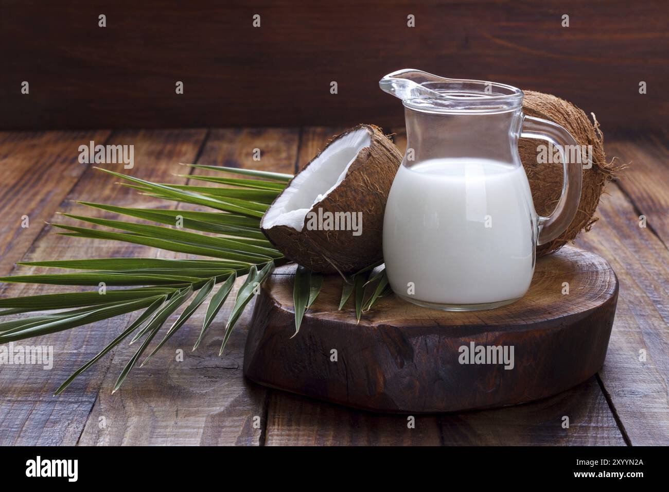 Coconut shell and milk on brown rustic background. Organic healthy food ...