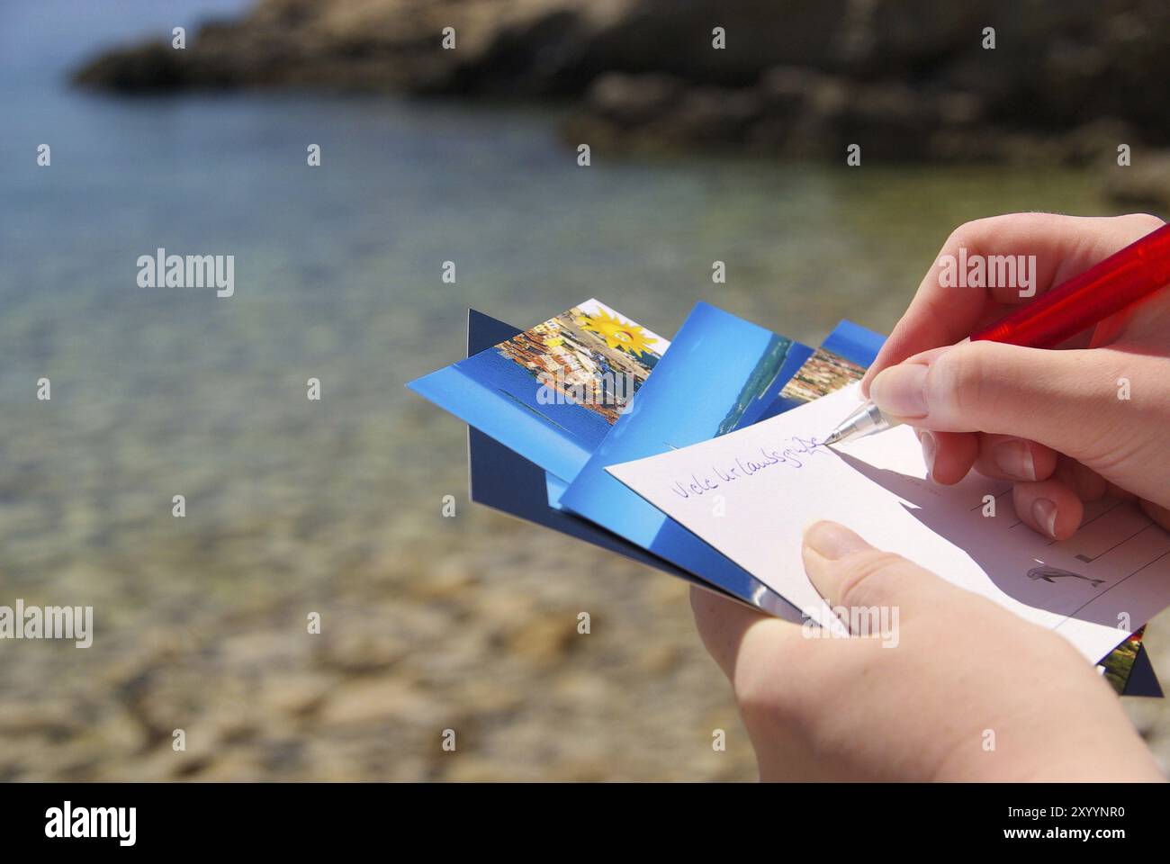 Postcard writing, writing a picture postcard Stock Photo - Alamy