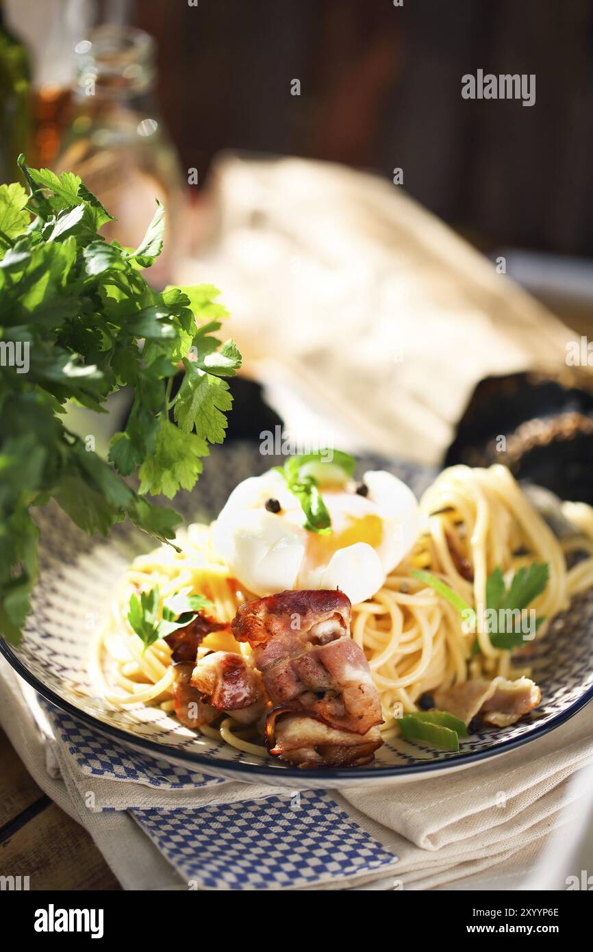 Nicely served spaghetti carbonara on black background with arty garnish ...