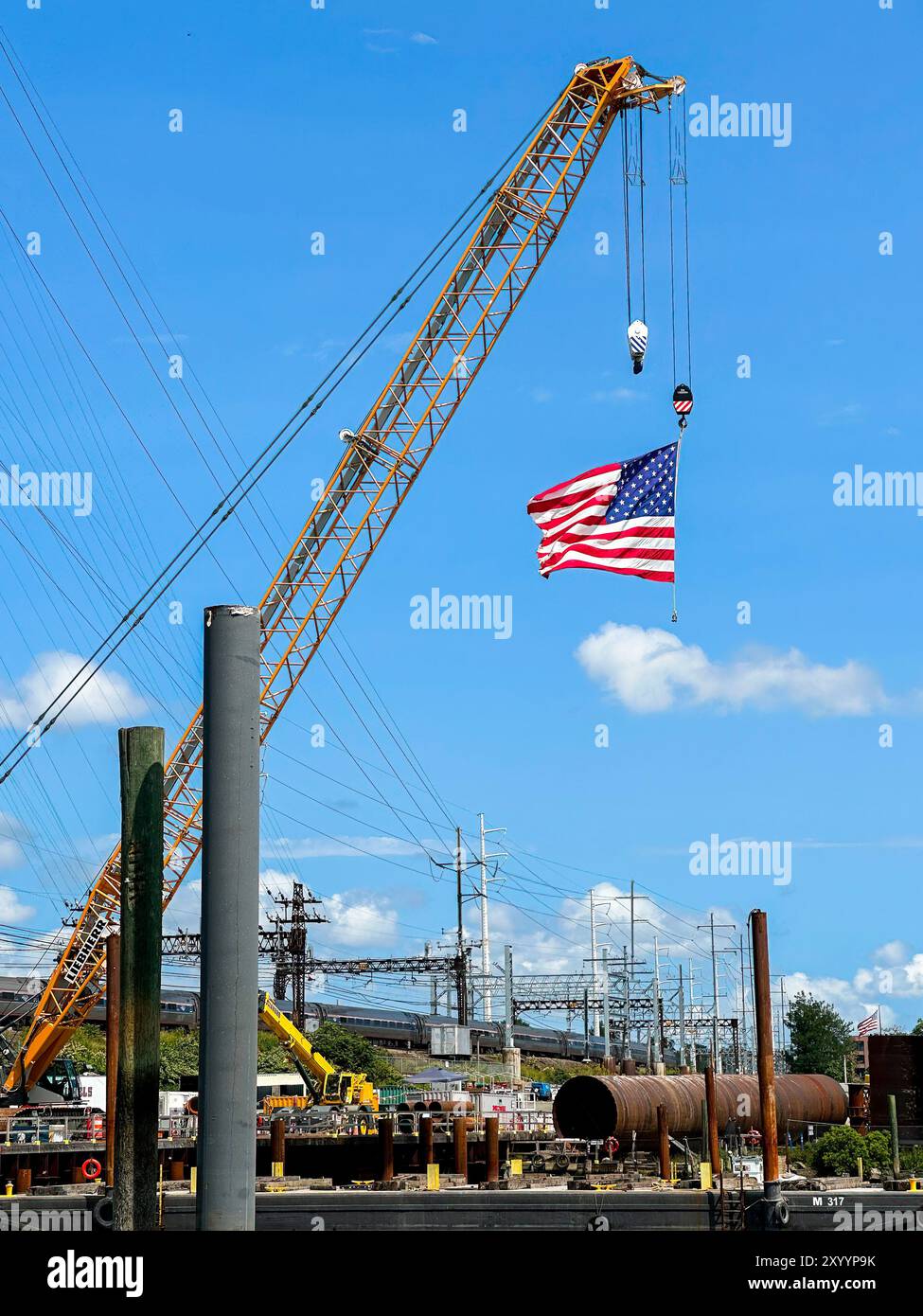 NORWALK, CT, USA - AUGUST 30, 2024: American flag hanging from crane on ...