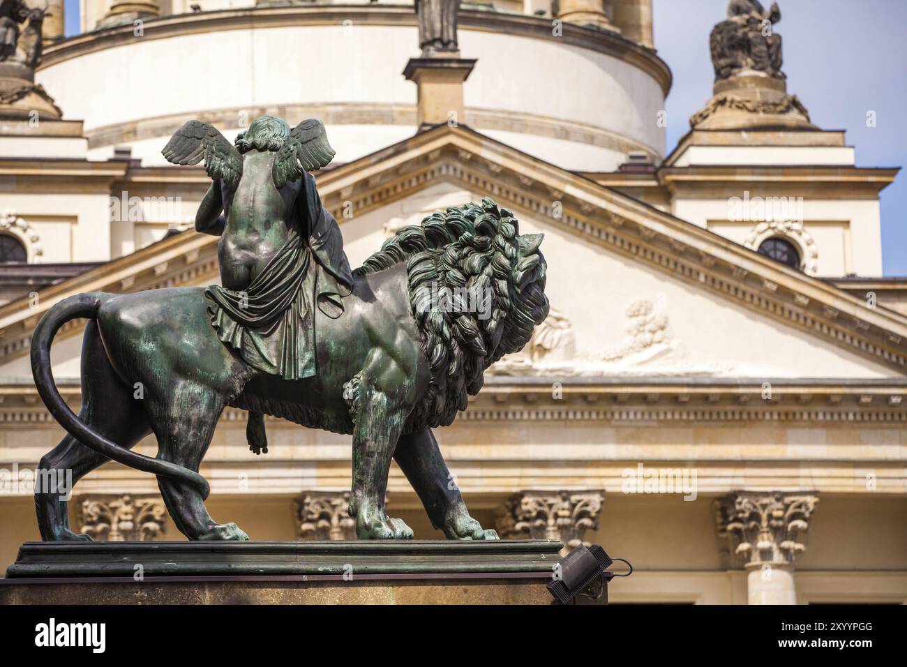 Statue of an angel riding a lion and playing the harp, with the French ...
