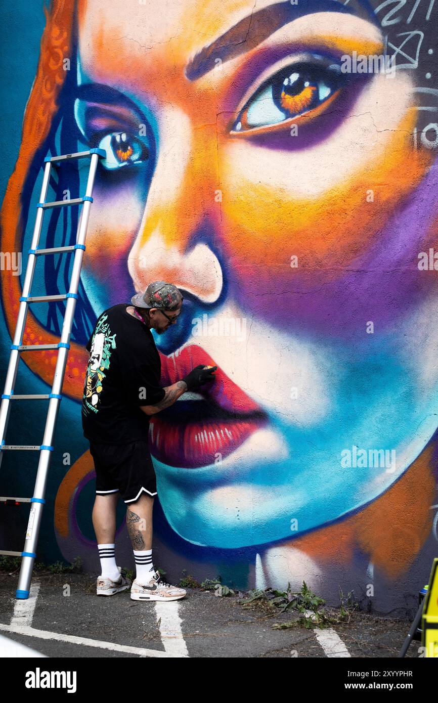 Graffiti artists creating street art pieces at the at the Southend City ...