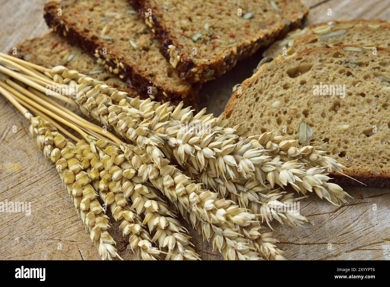 Top view of sliced wholegrain bread on a wooden table. Different types ...