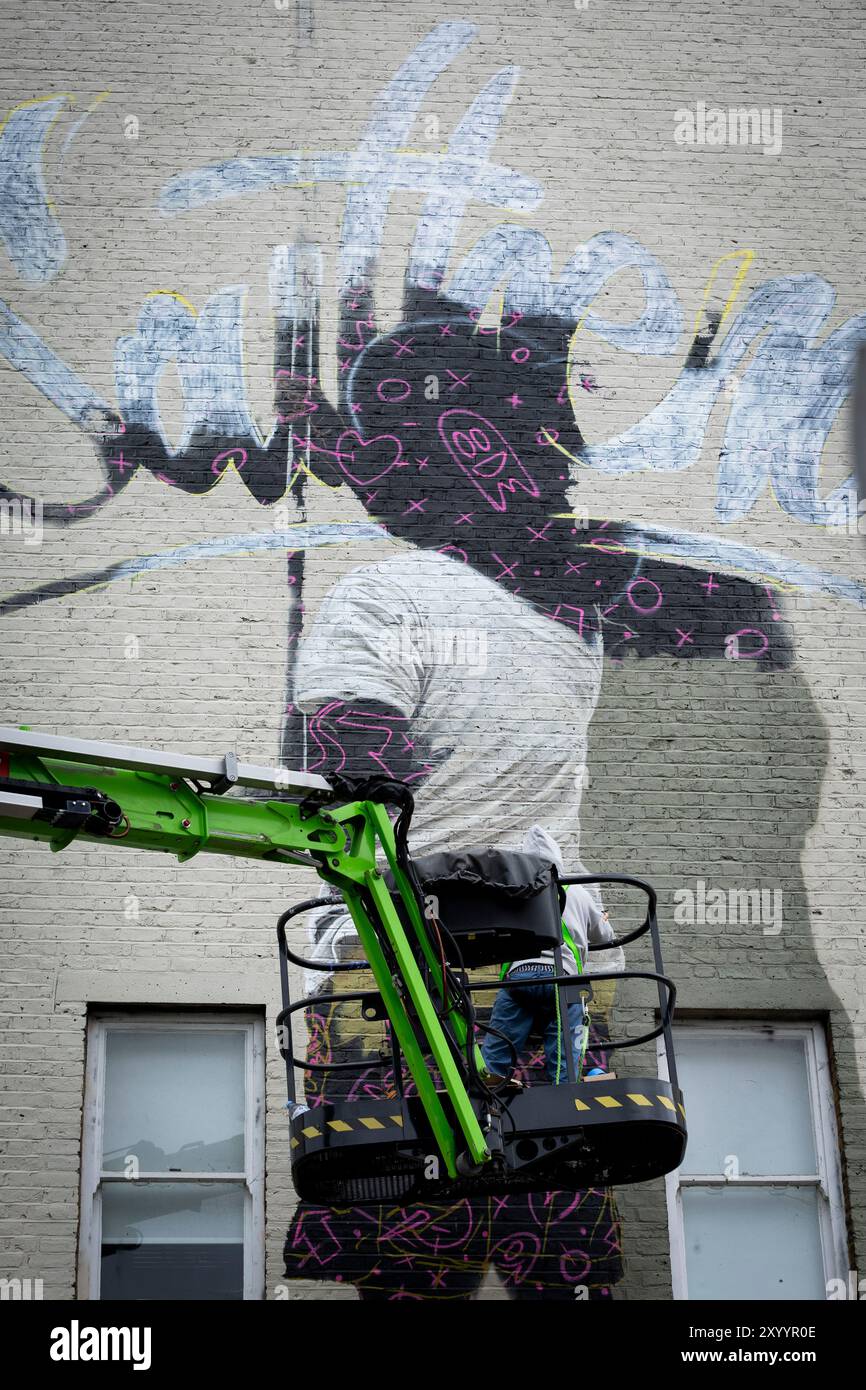 Graffiti artists creating street art pieces at the at the Southend City ...