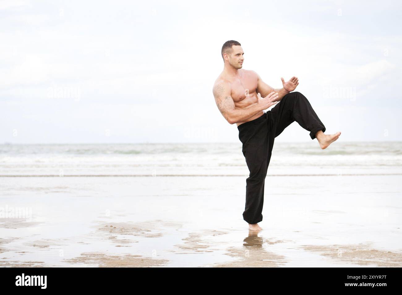 Man training karate at the beach Stock Photo - Alamy