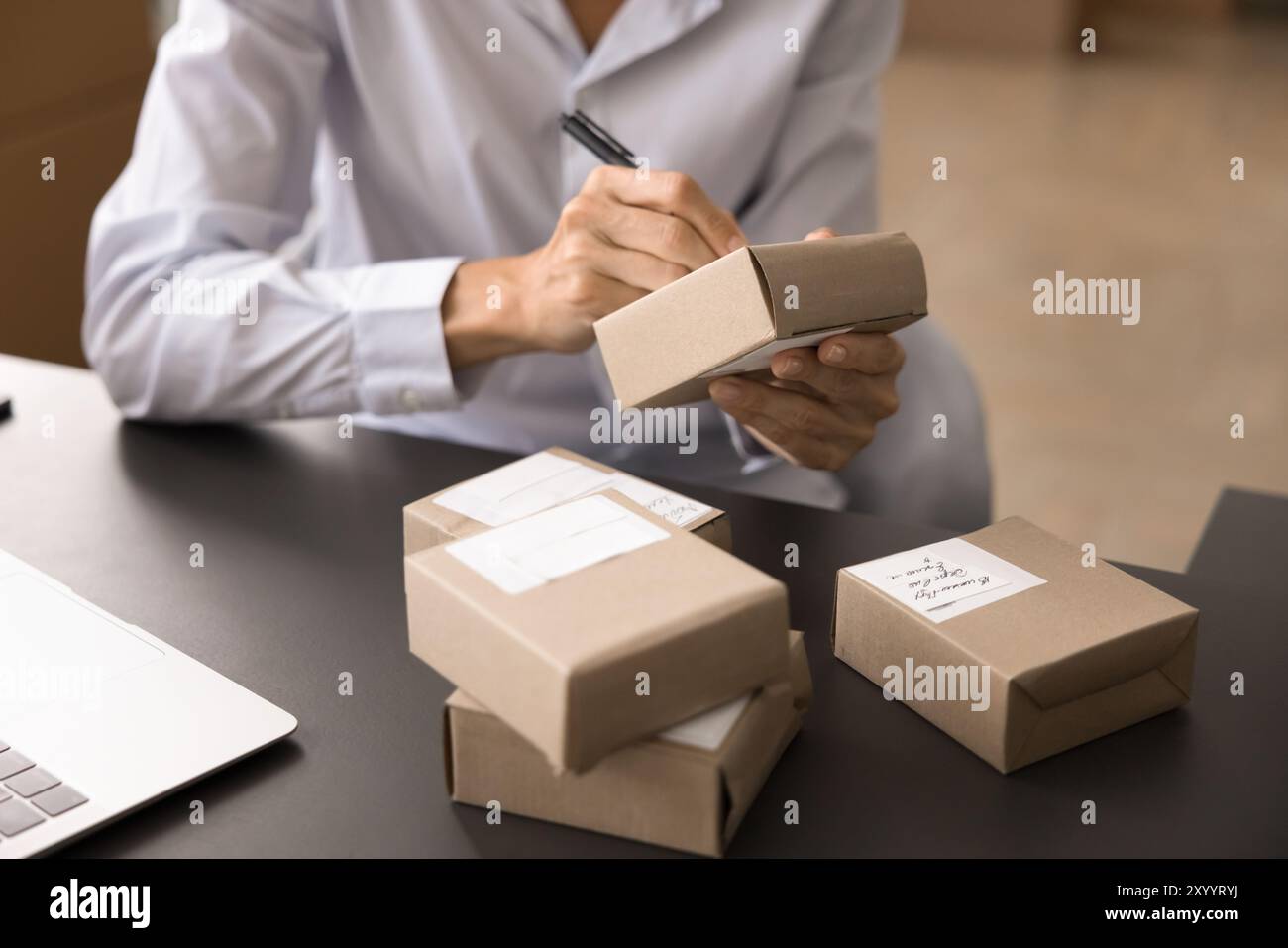 Woman preparing parcels shipment hi-res stock photography and images ...