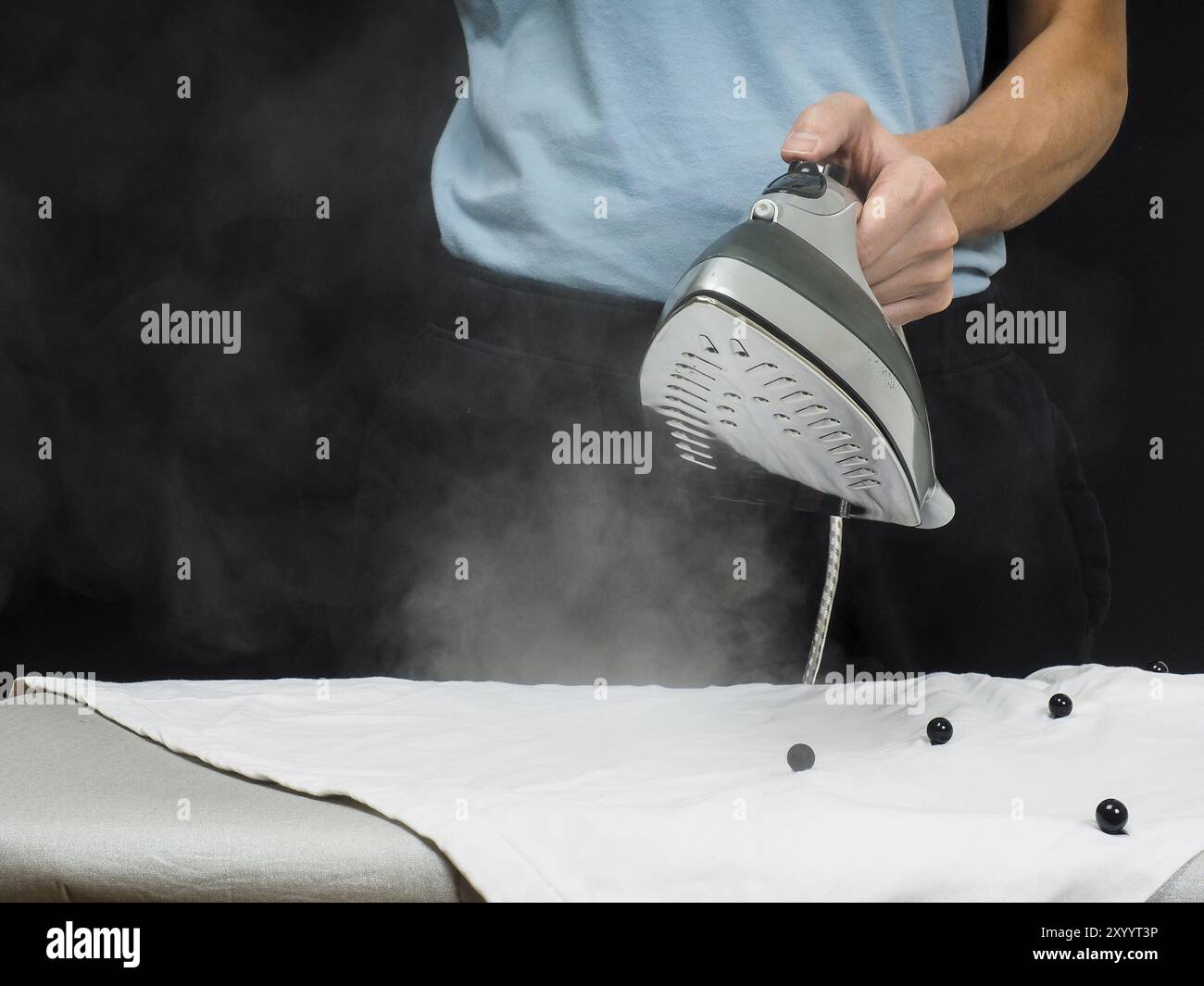 Male person using a steaming hot iron, on a white shirt Stock Photo - Alamy