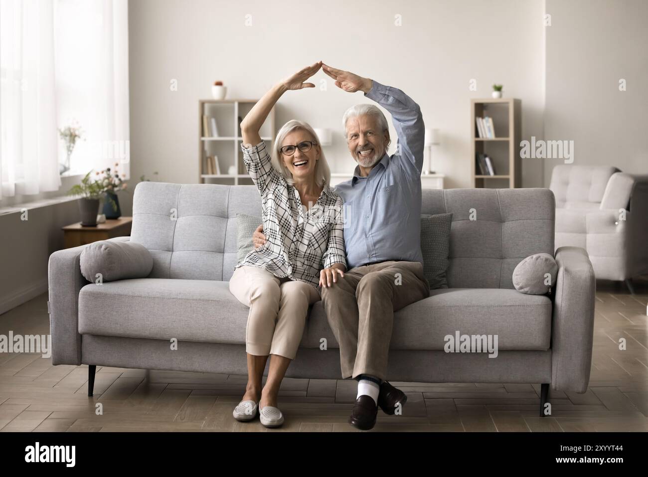 Couple join their hands showing roof over their heads Stock Photo - Alamy