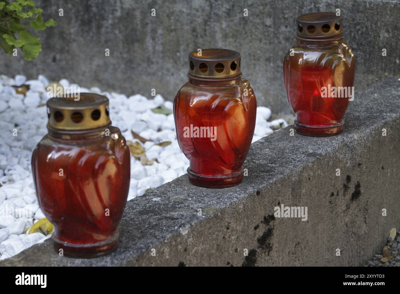 Three grave lights on one grave Stock Photo - Alamy