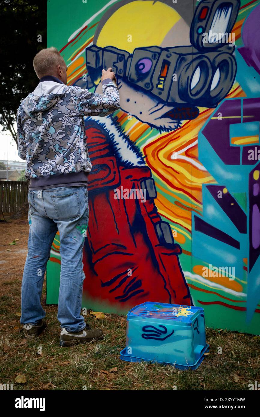Graffiti artists creating street art pieces at the at the Southend City ...
