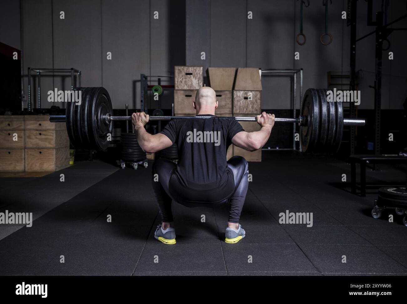 Athletic Muscular Man Lifting Weights and Doing Back Squat in Gym ...