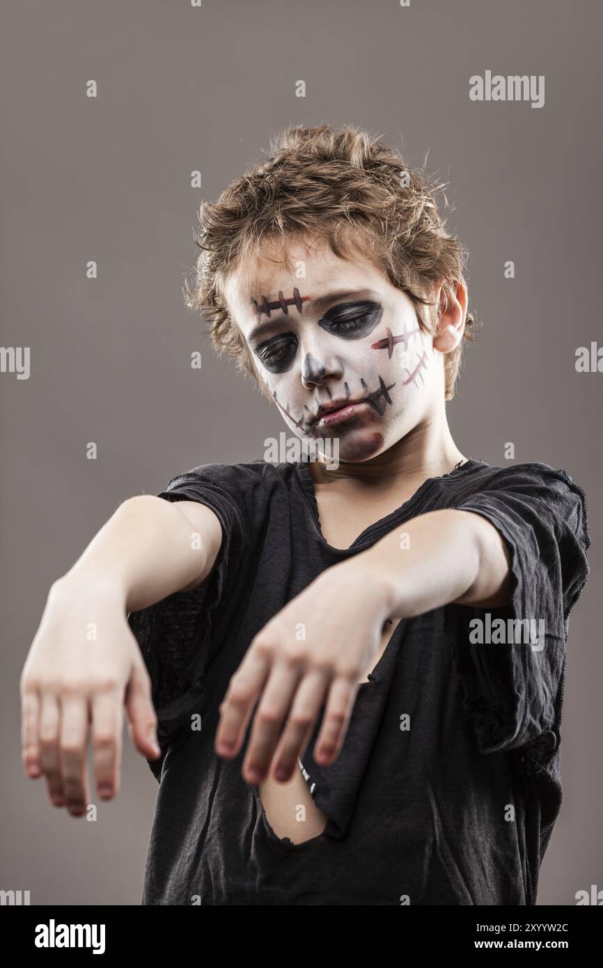 Halloween or horror concept, screaming walking dead zombie child boy ...