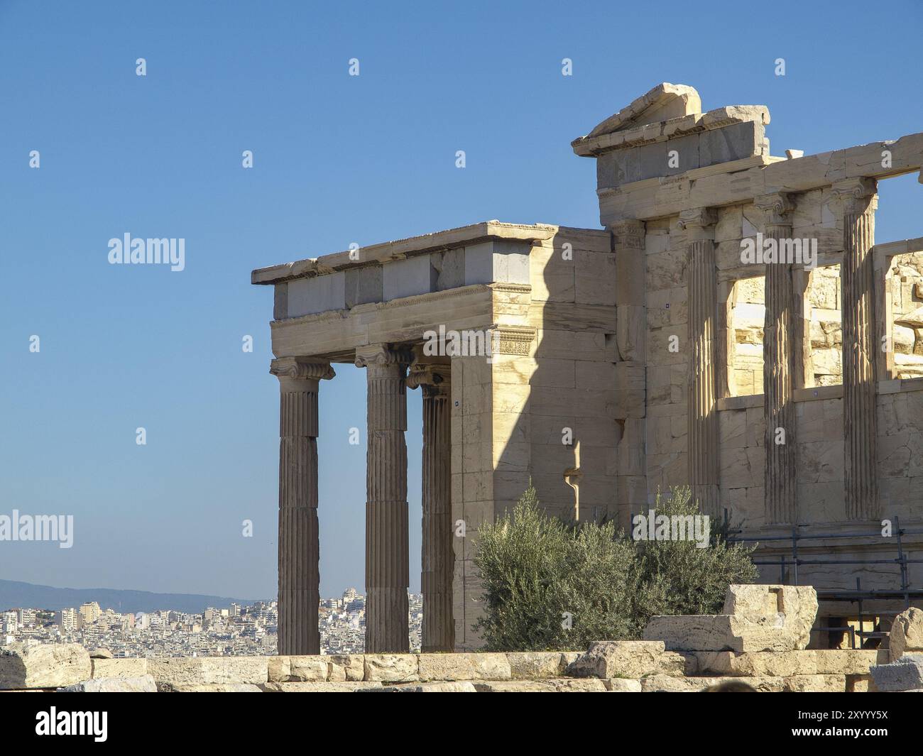 Ancient ruins with stone columns and plants under a clear blue sky, athens, greece Stock Photo ...