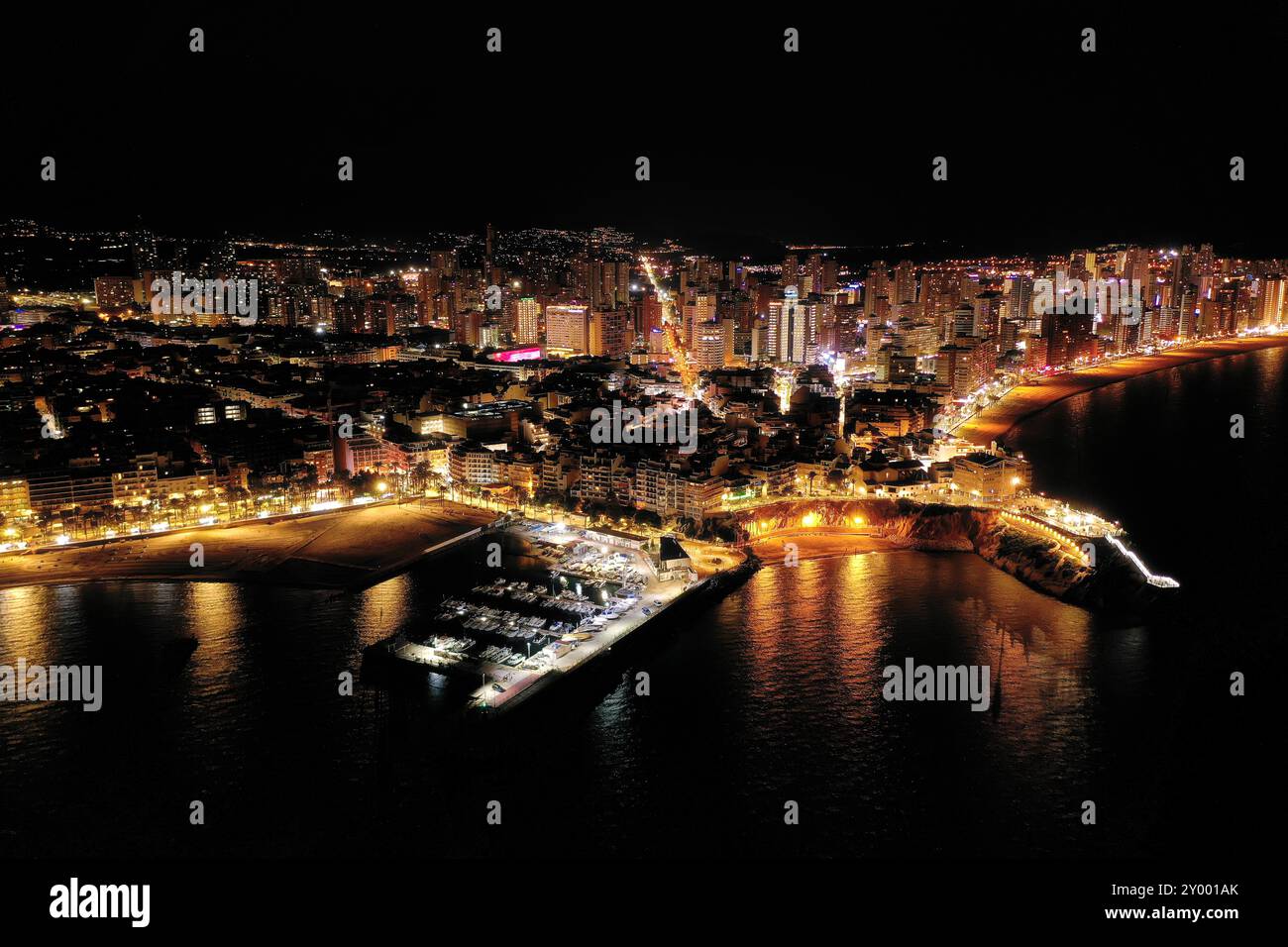 Benidorm skyline at night. Streetlight reflecting in water. Famous ...