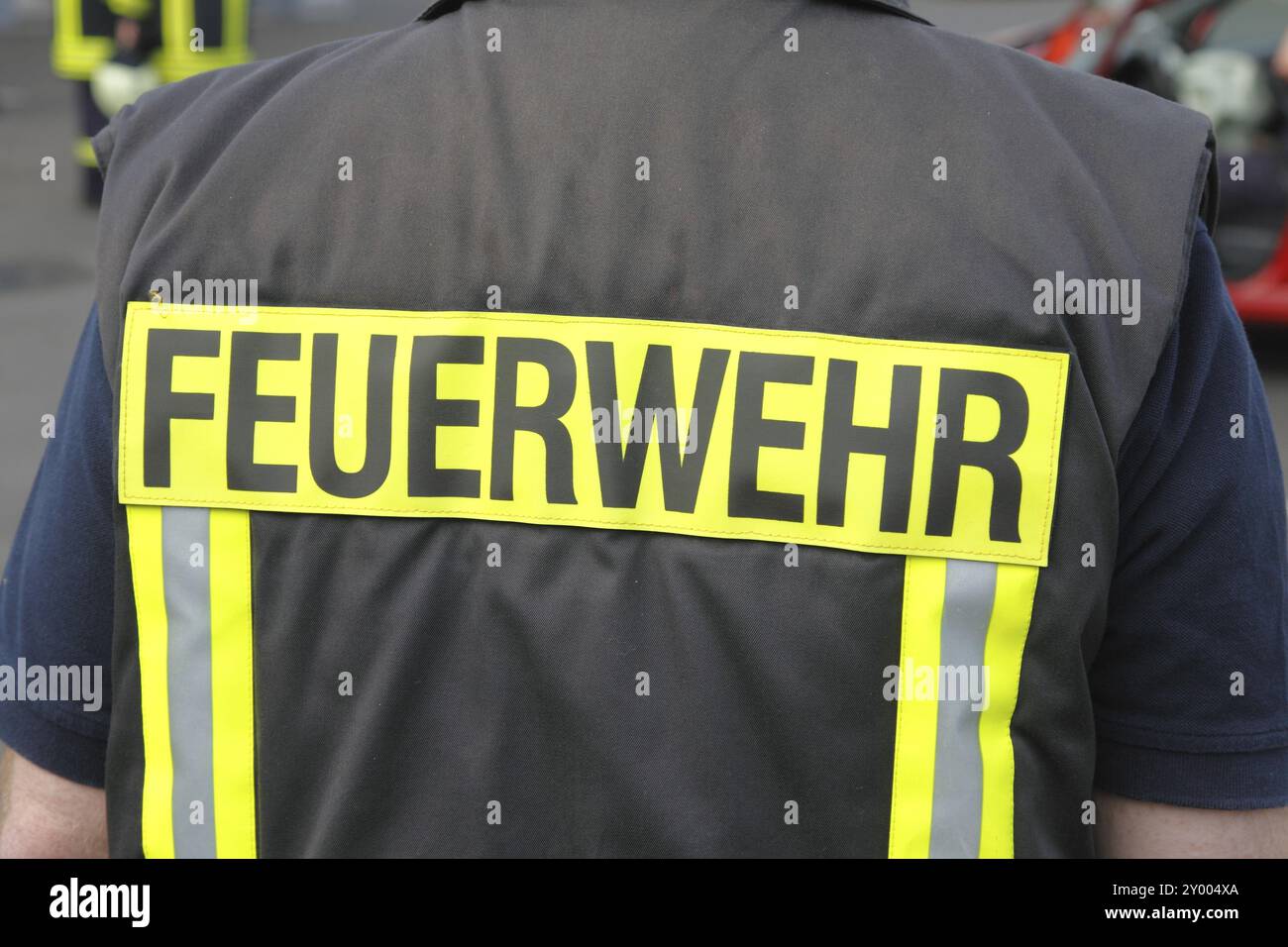 Firefighter back view with fire brigade lettering Stock Photo - Alamy