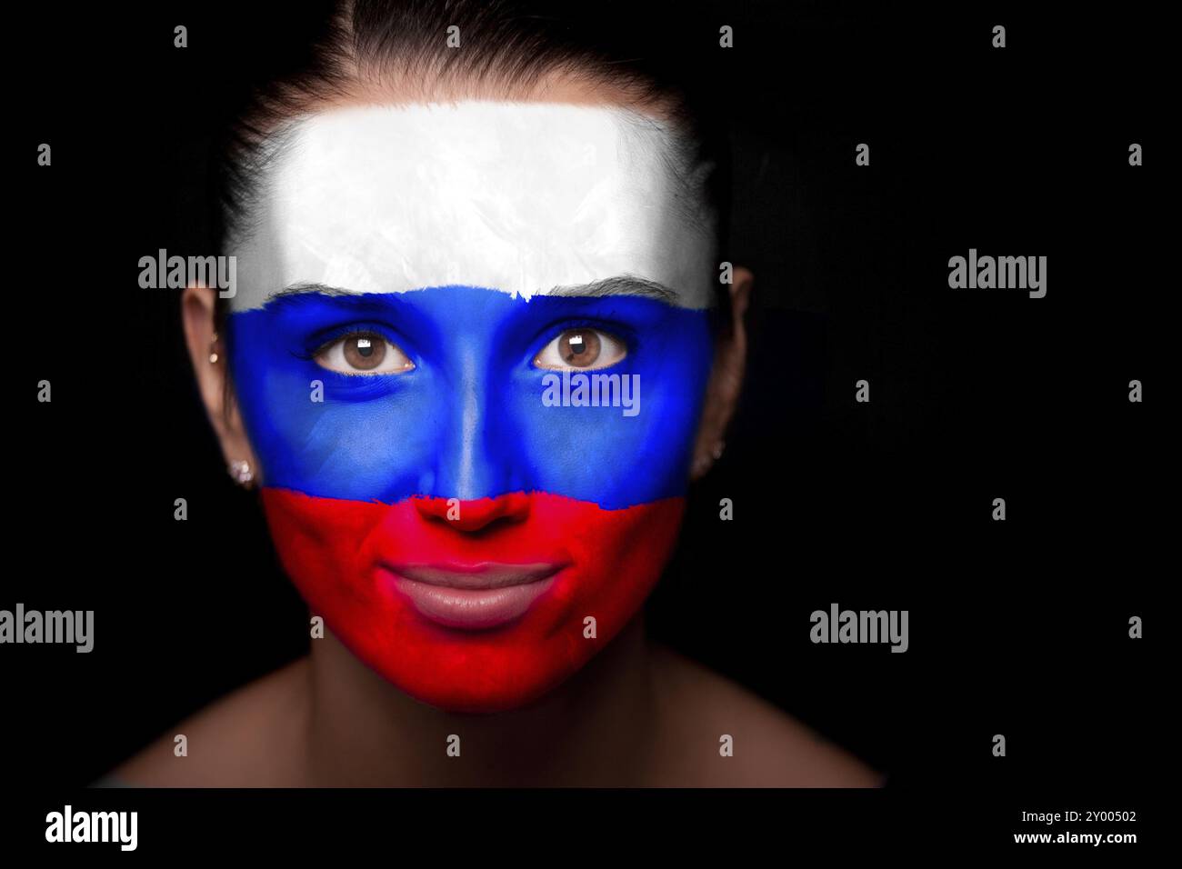 Portrait of a woman with the flag of the Russia painted on her face ...
