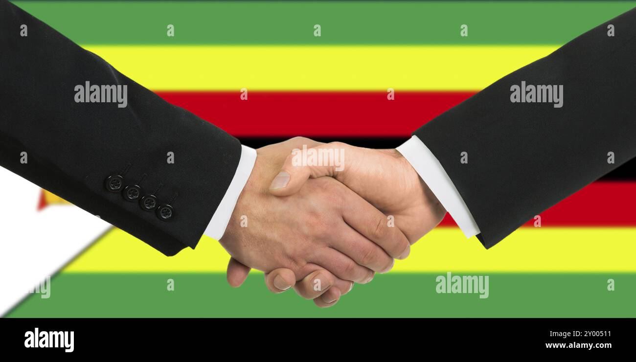 The Zimbabwe flag and business handshake Stock Photo - Alamy
