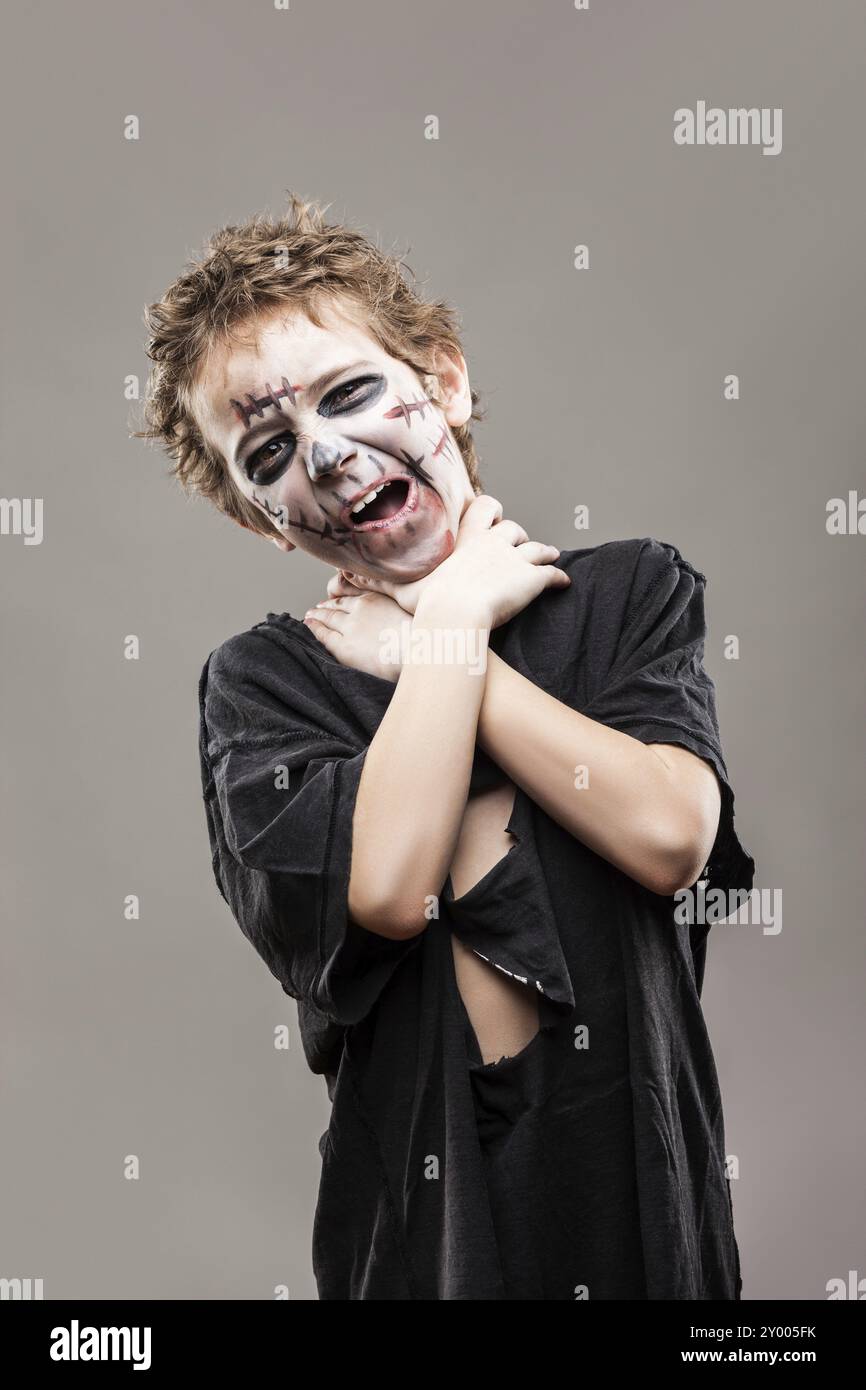 Halloween or horror concept, screaming walking dead zombie child boy ...