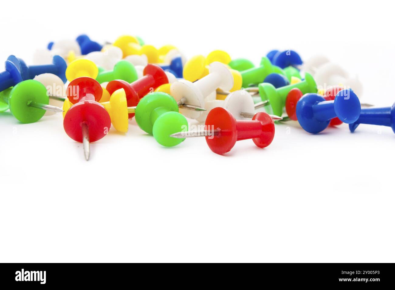 Colorful mixed-up pins isolated on white Stock Photo - Alamy