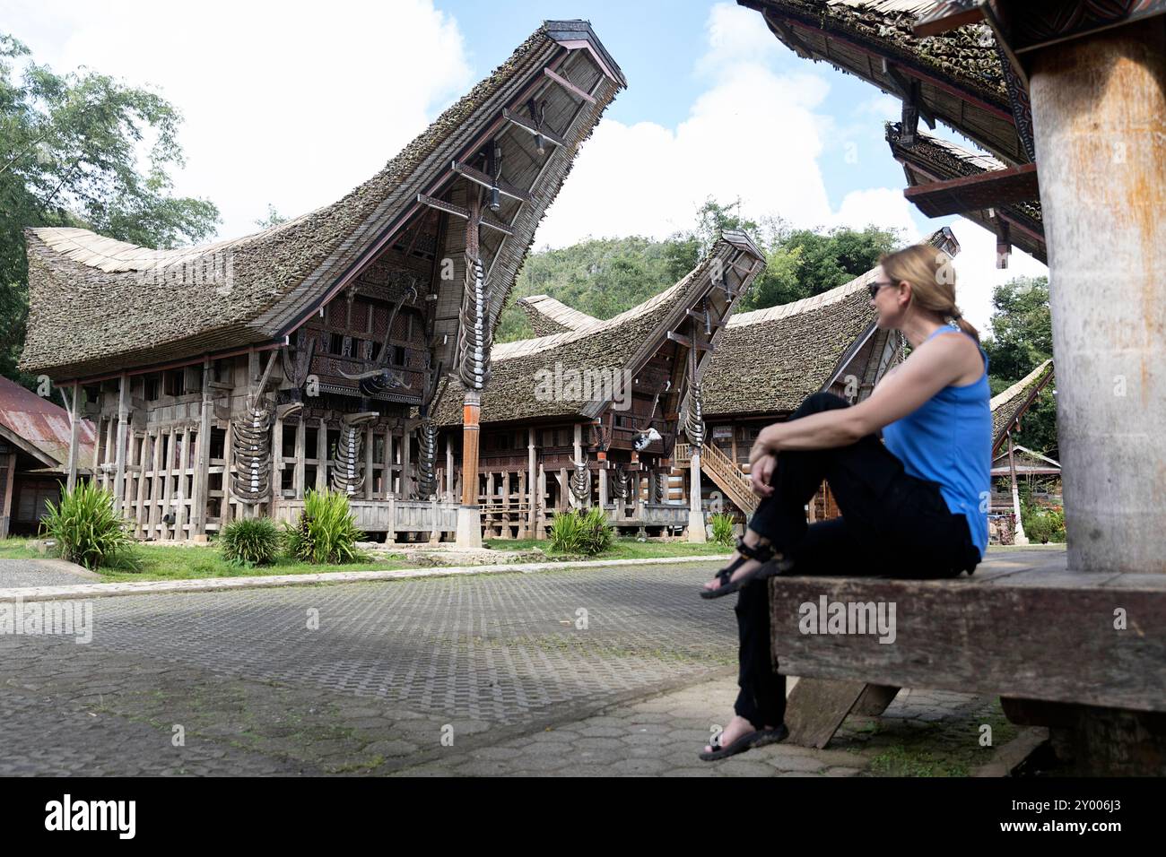Tourist woman sitting at Ke'te Kesu, traditional village with old decorated houses called ...