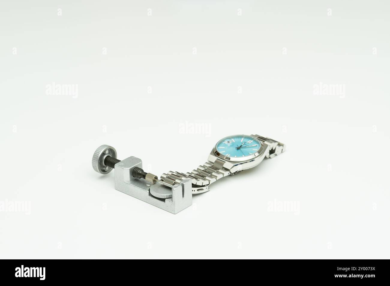 Adjusting watch strap with link remover tool Stock Photo - Alamy