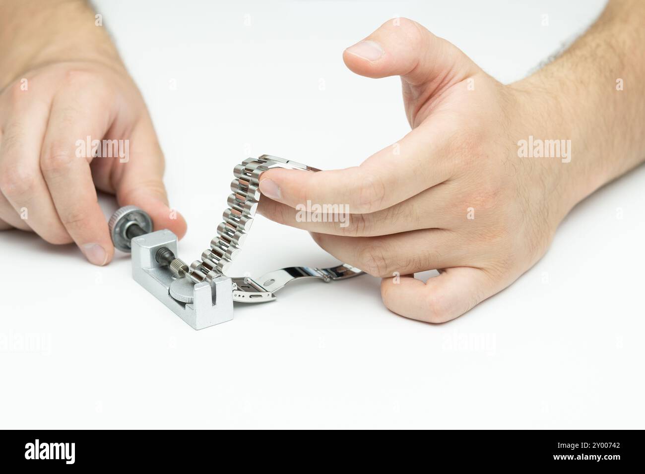 Adjusting watch strap with link remover tool Stock Photo - Alamy