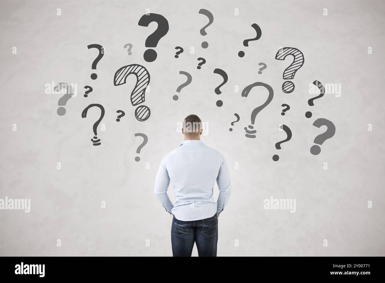 Backside of a young fit man with question marks around him, isolated in ...