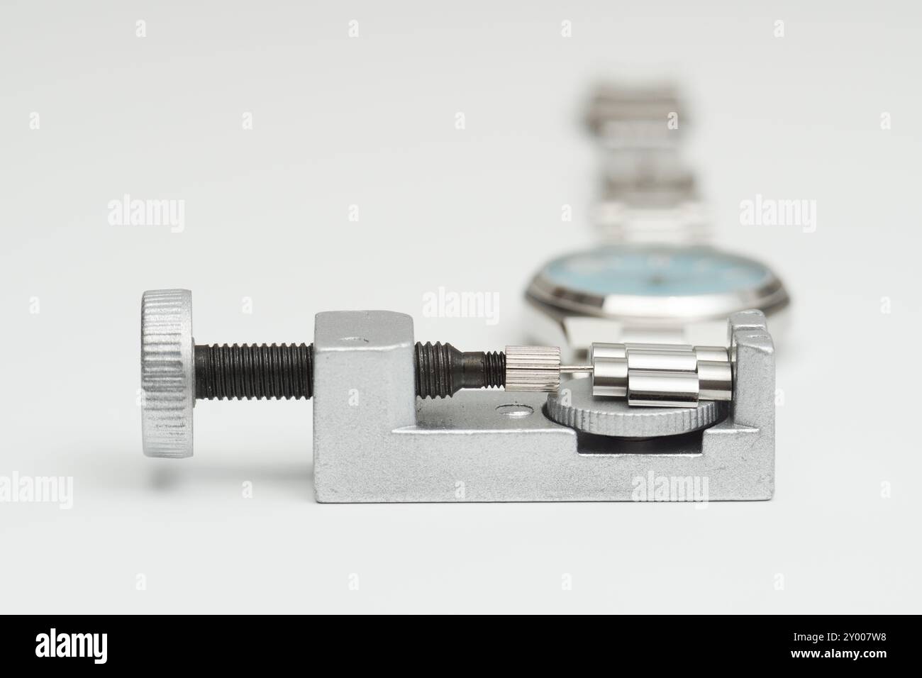 Adjusting watch strap with link remover tool Stock Photo - Alamy