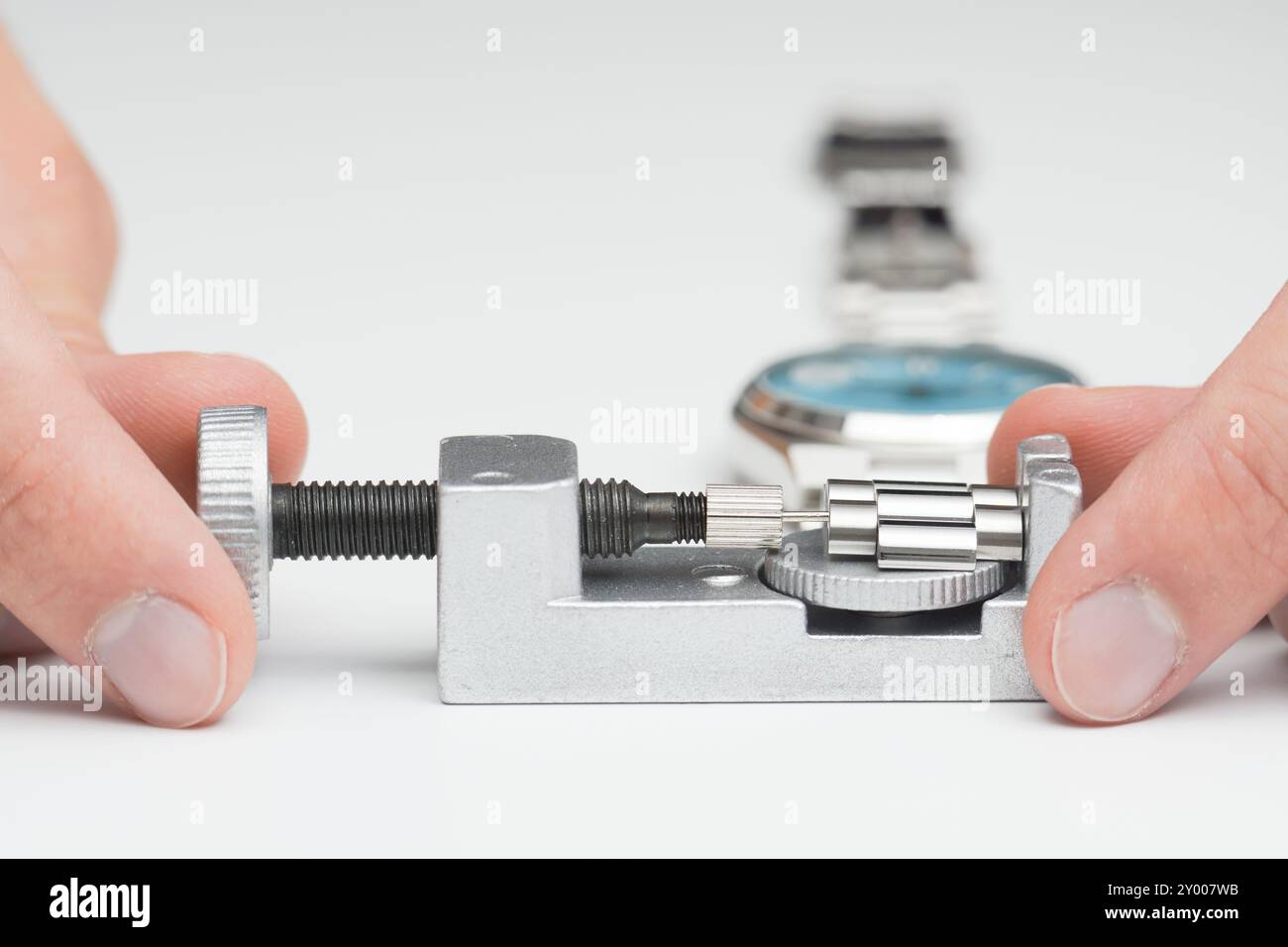 Adjusting watch strap with link remover tool Stock Photo - Alamy