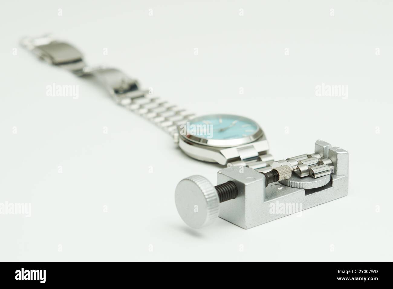 Adjusting watch strap with link remover tool Stock Photo - Alamy