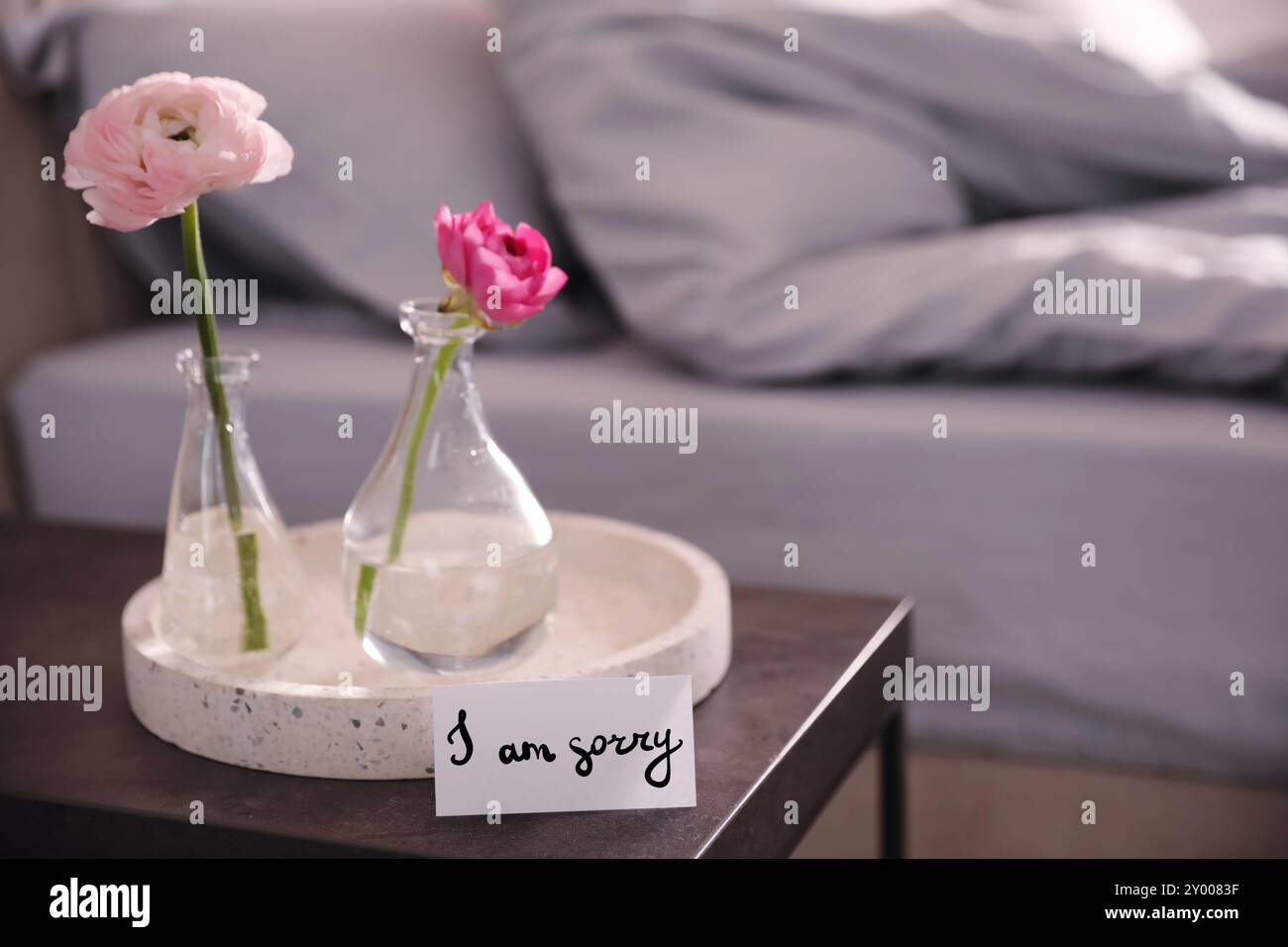Sorry card and flowers on bedside table in room. Space for text Stock ...