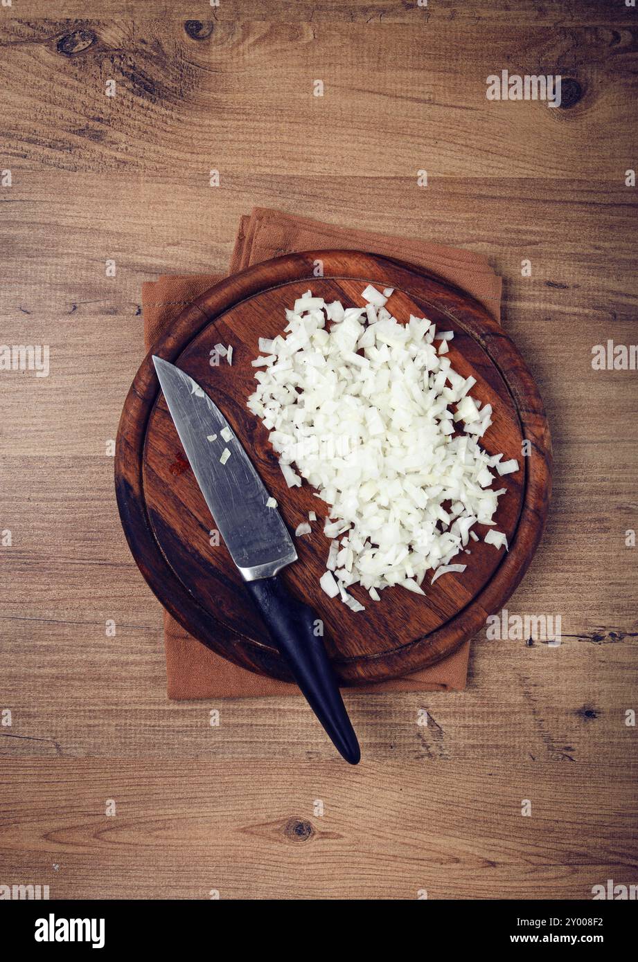 Finely chopped onion on a chopping board with a knife, wooden table, top view, no people Stock ...