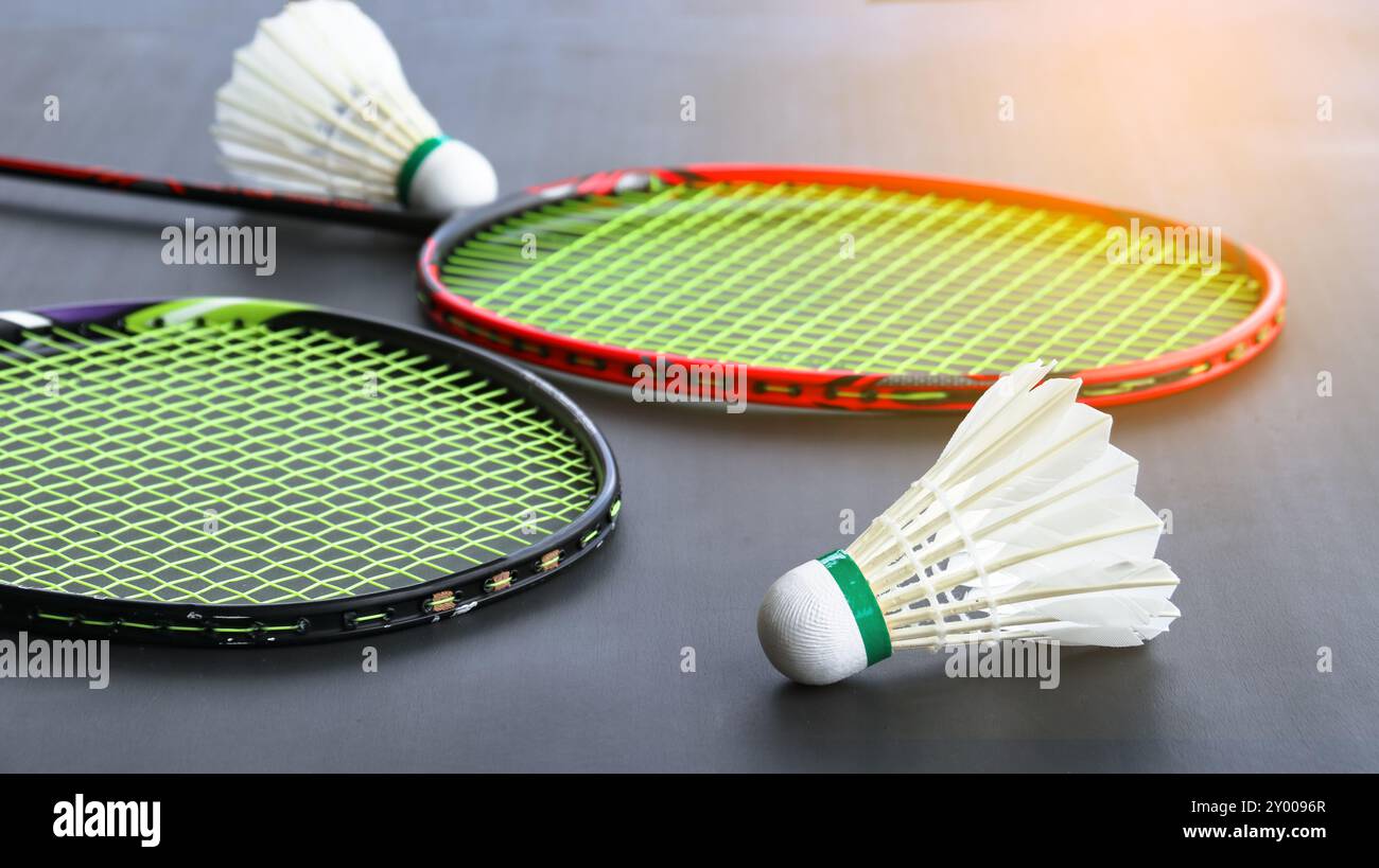 Badminton shuttlecocks with rackets on a dark background symbolizing ...