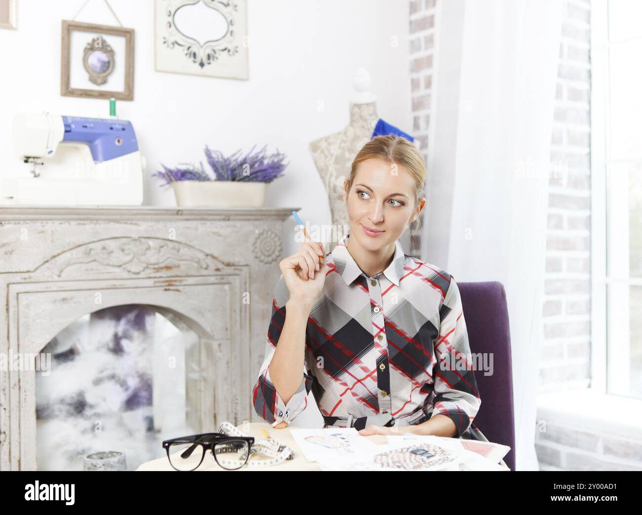 Dressmaker is drawing a fashion sketches in studio Stock Photo - Alamy