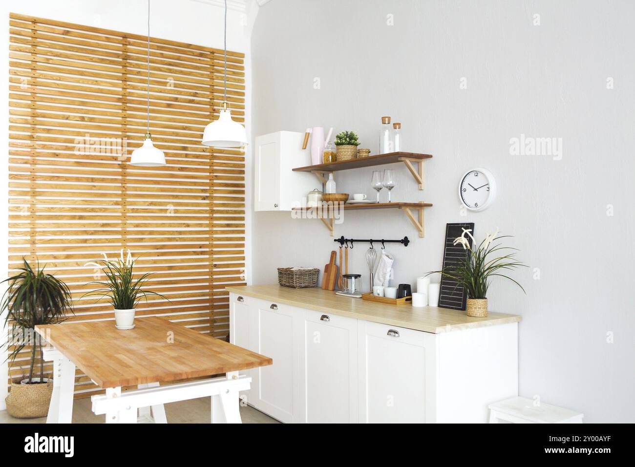Interior of empty modern white kitchen with various objects on the ...