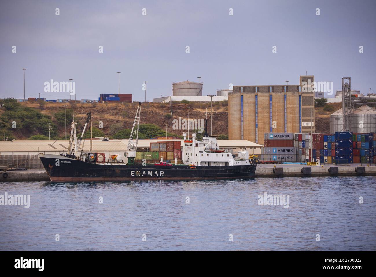 Black cargo ship at anchor in a harbour Stock Photo - Alamy