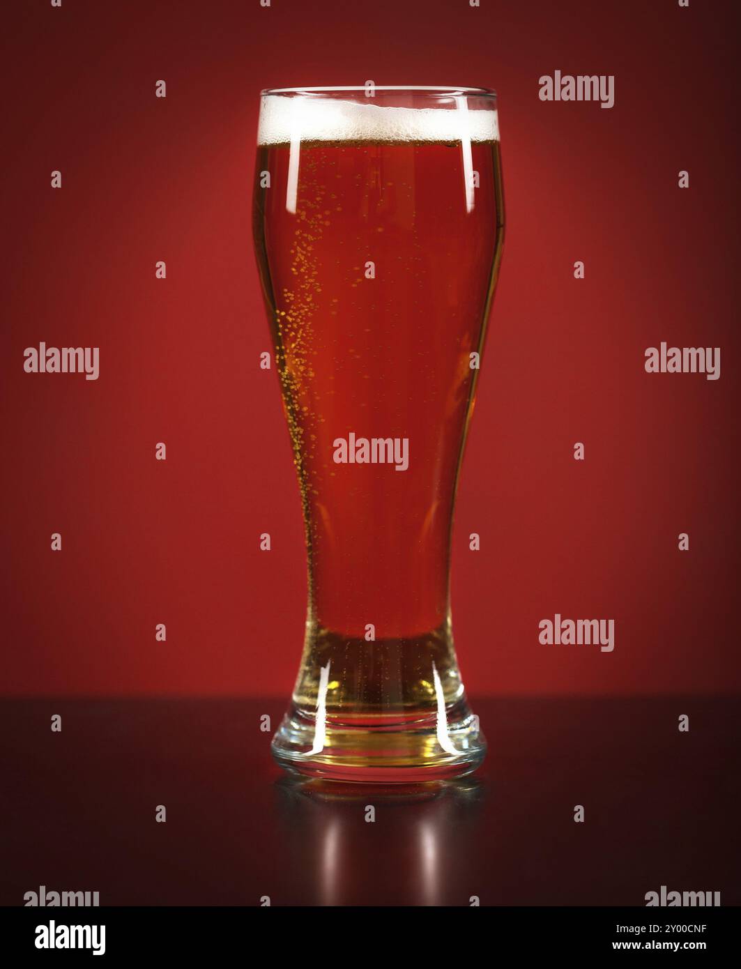 Still life with a draft beer by the glass ob red background Stock Photo ...