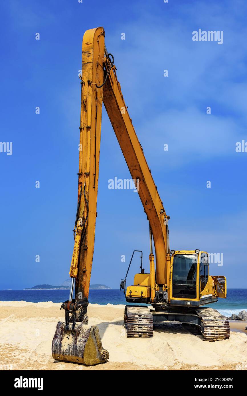 Yellow excavator cabin and arm over sand at beach in a sunny day Stock ...